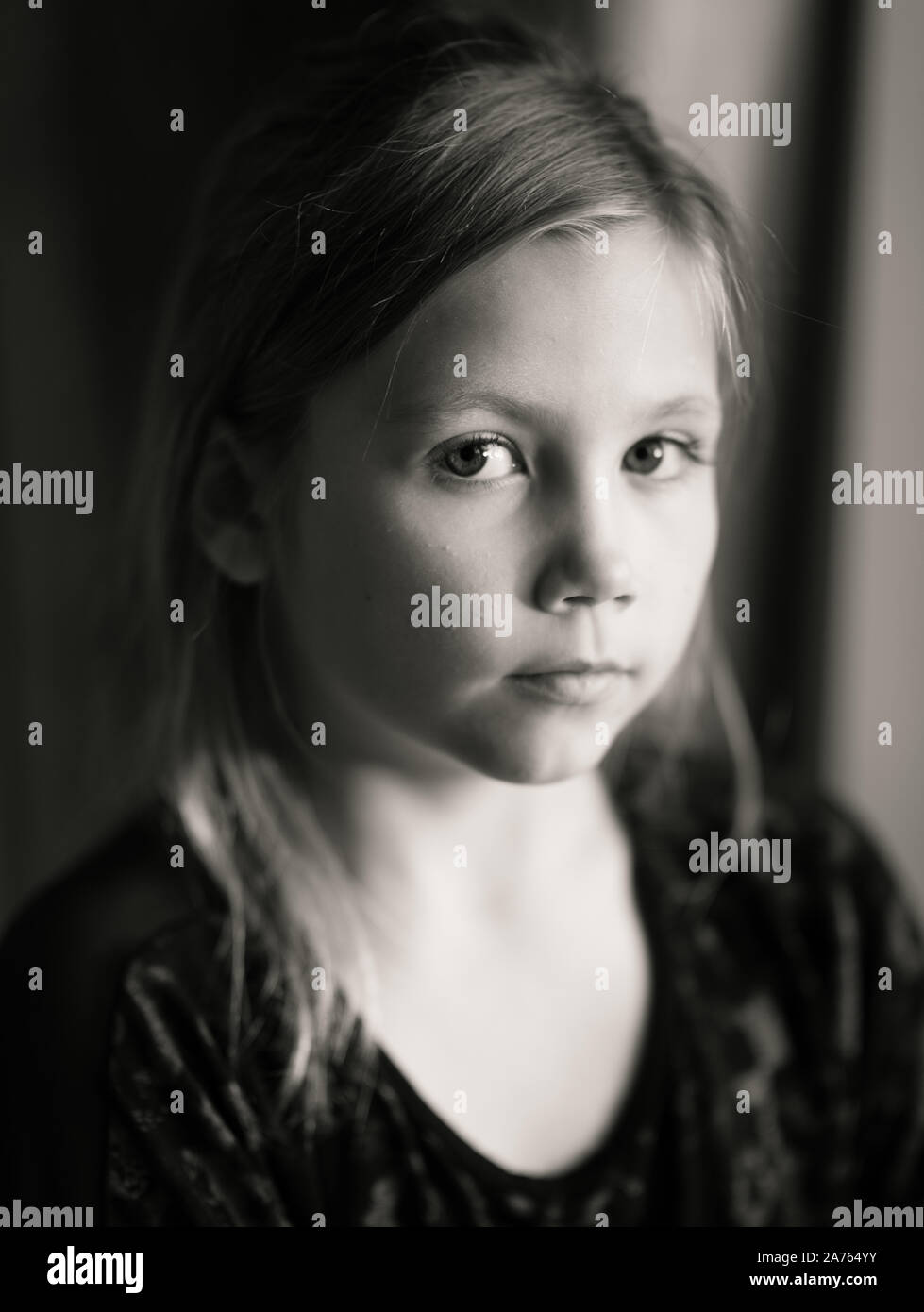 Young girl looking at the camera Stock Photo - Alamy