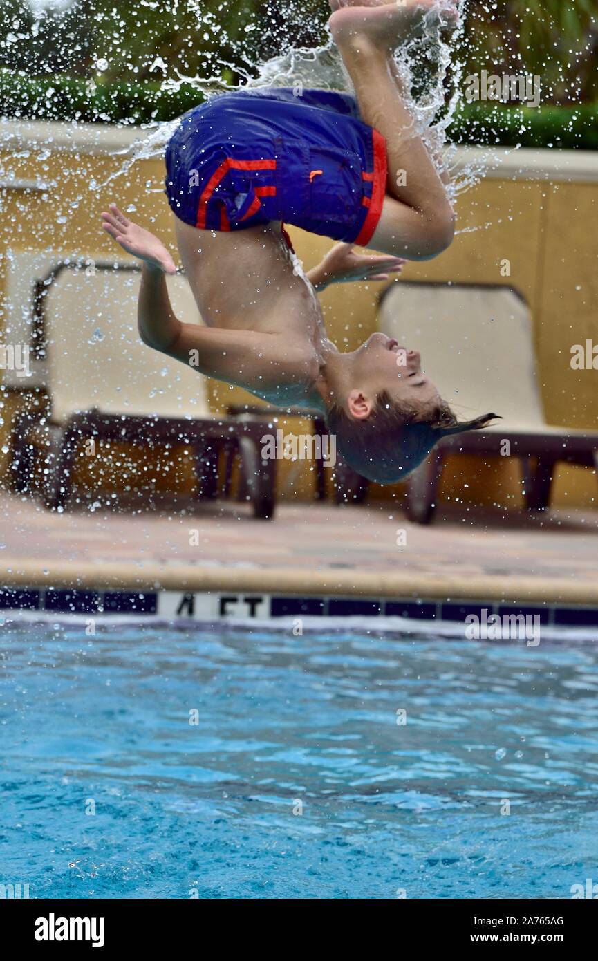 A young boy does a flip in a hotel pool Stock Photo - Alamy