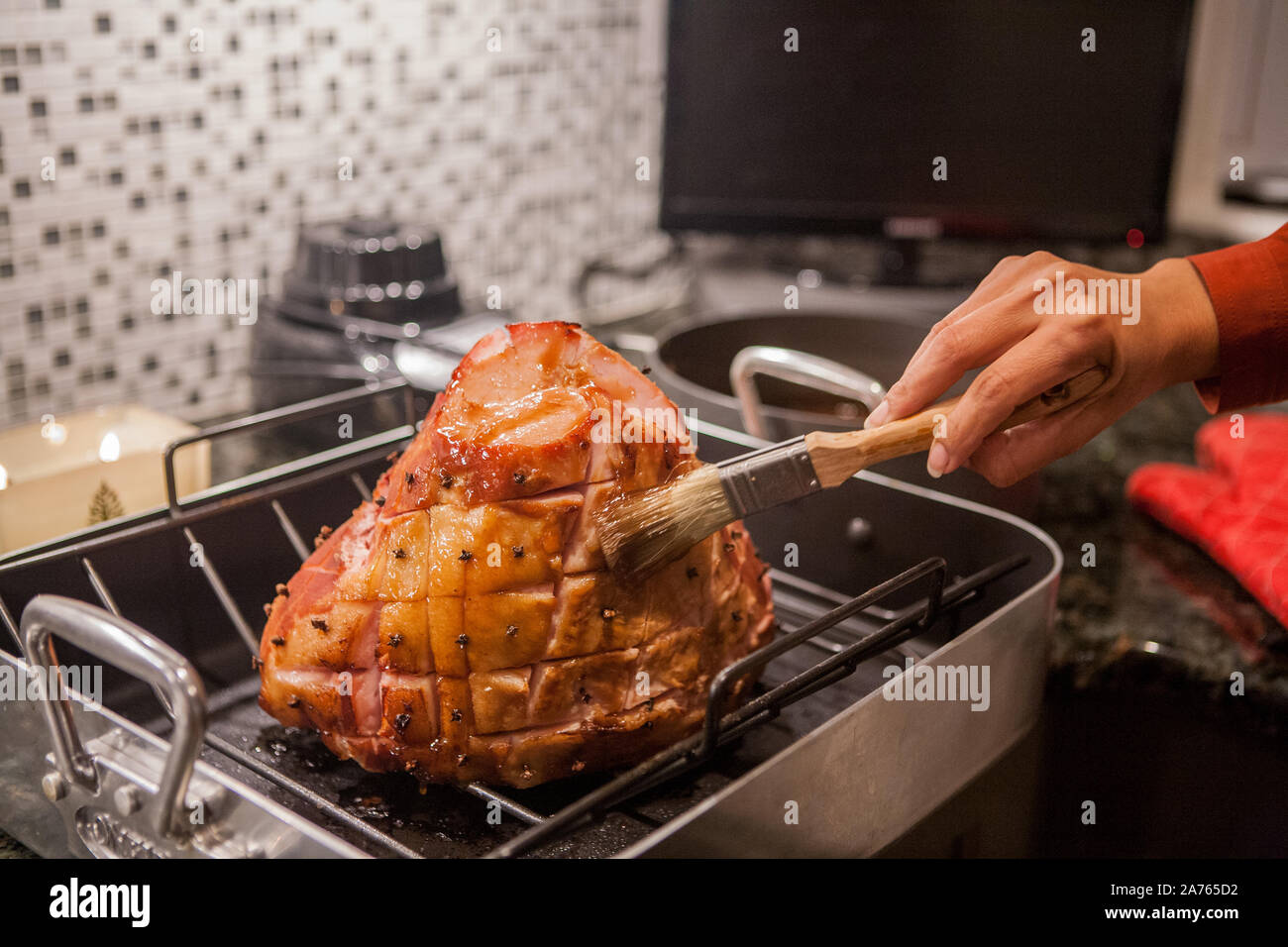 Woman glazing ham Stock Photo - Alamy