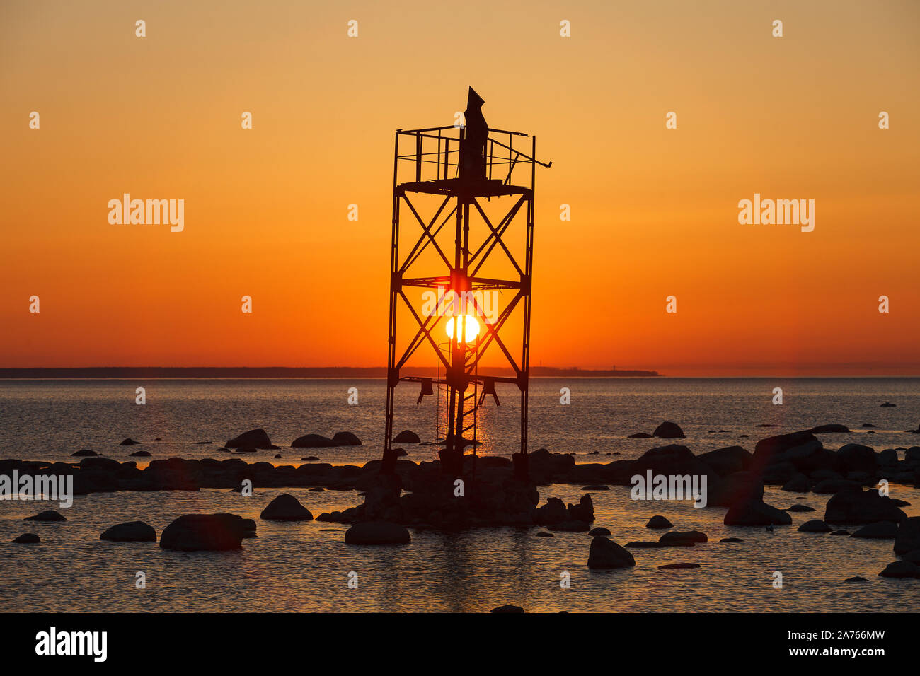 Monk in standing on the sinking watchtower in the sea at sunset Stock ...