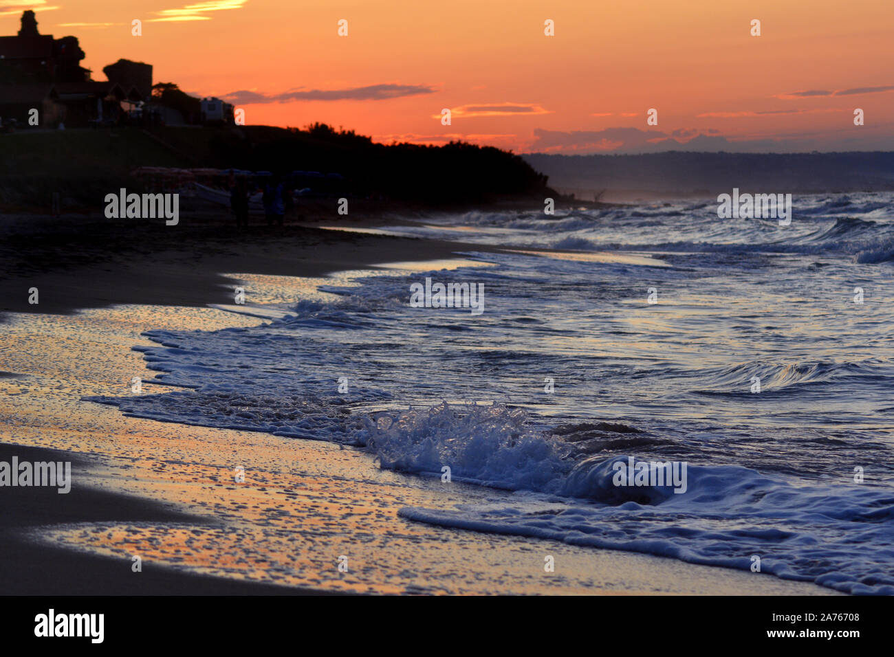 Orange sunset on a sand beach of Adriatic sea Stock Photo - Alamy