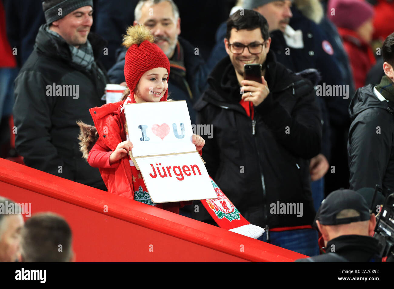 A young Liverpool fan with a banner in support of Liverpool manager ...