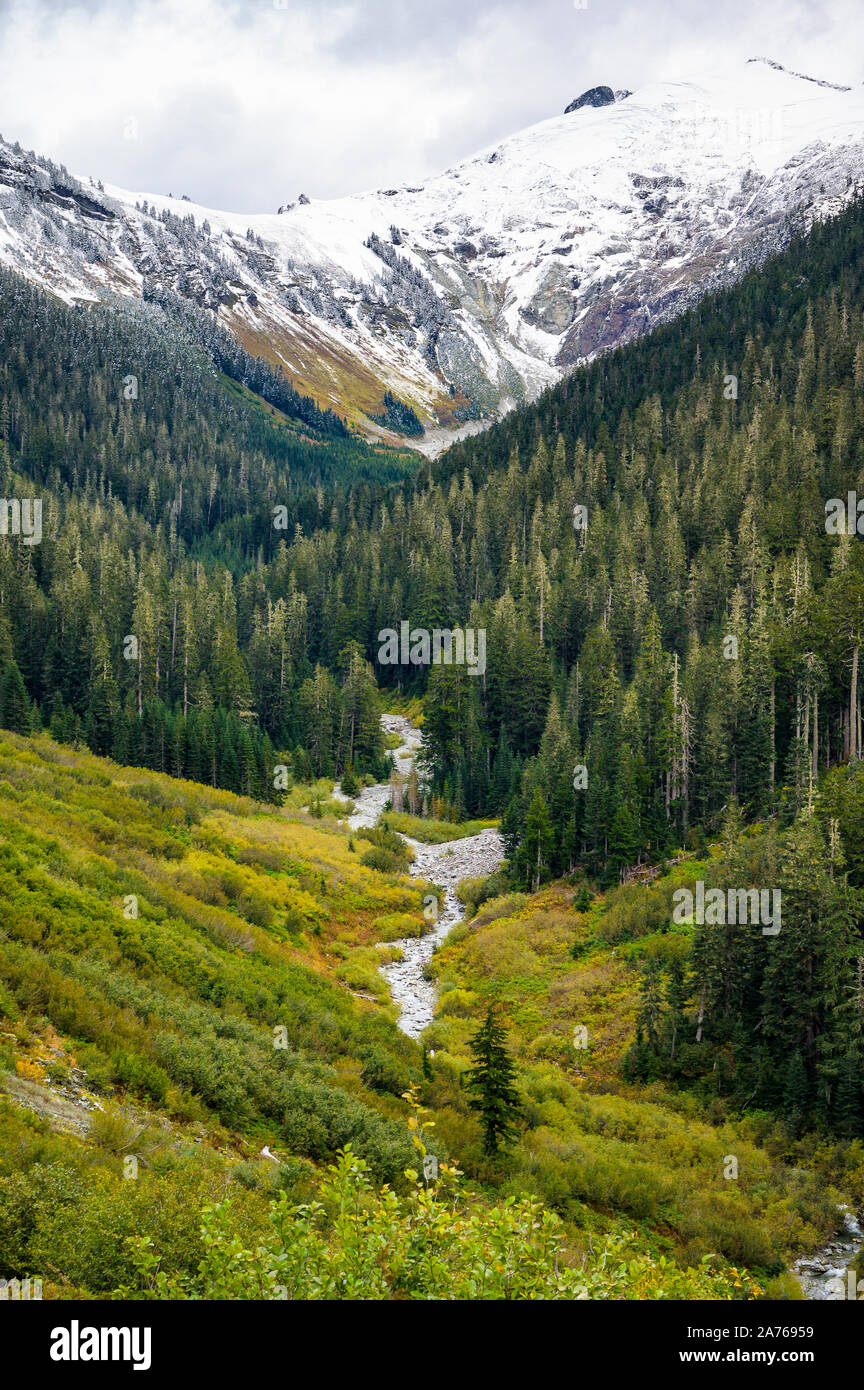 Snow Covered Mountain Behind Valley With Fall Colors Stock Photo - Alamy
