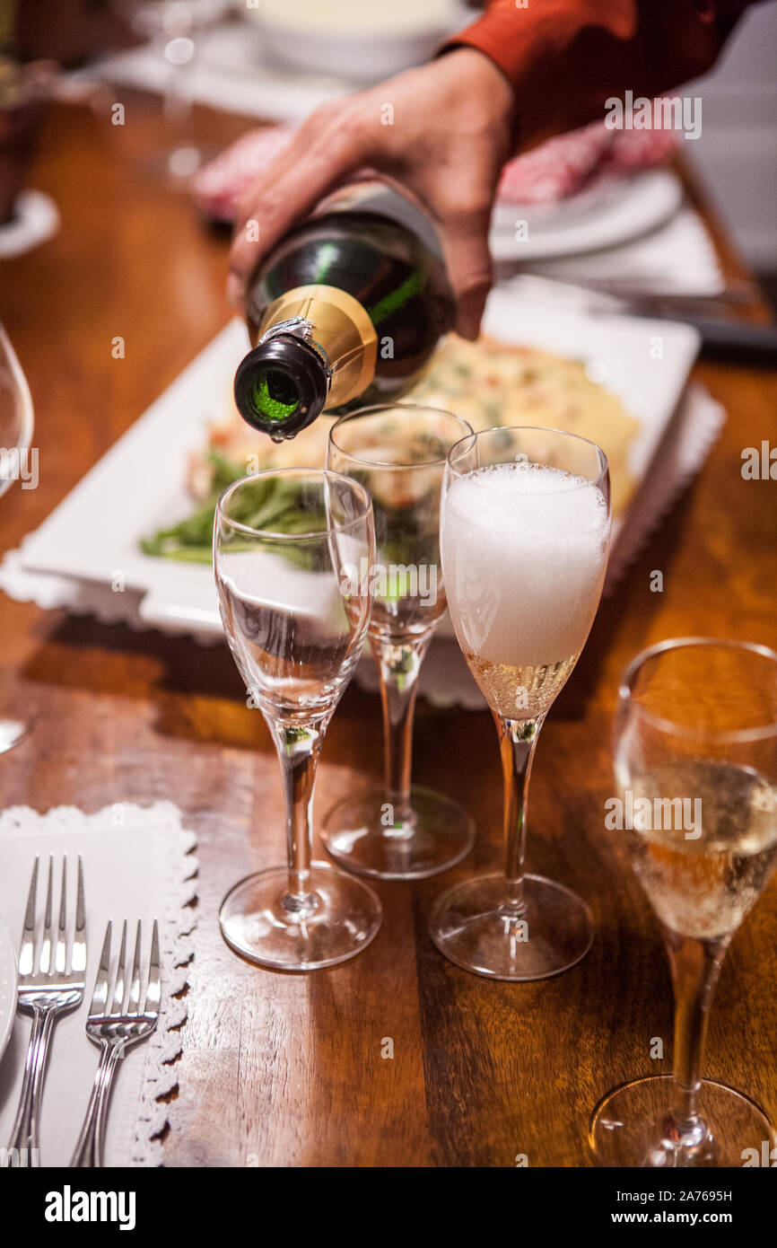 Woman serving champagne Stock Photo - Alamy