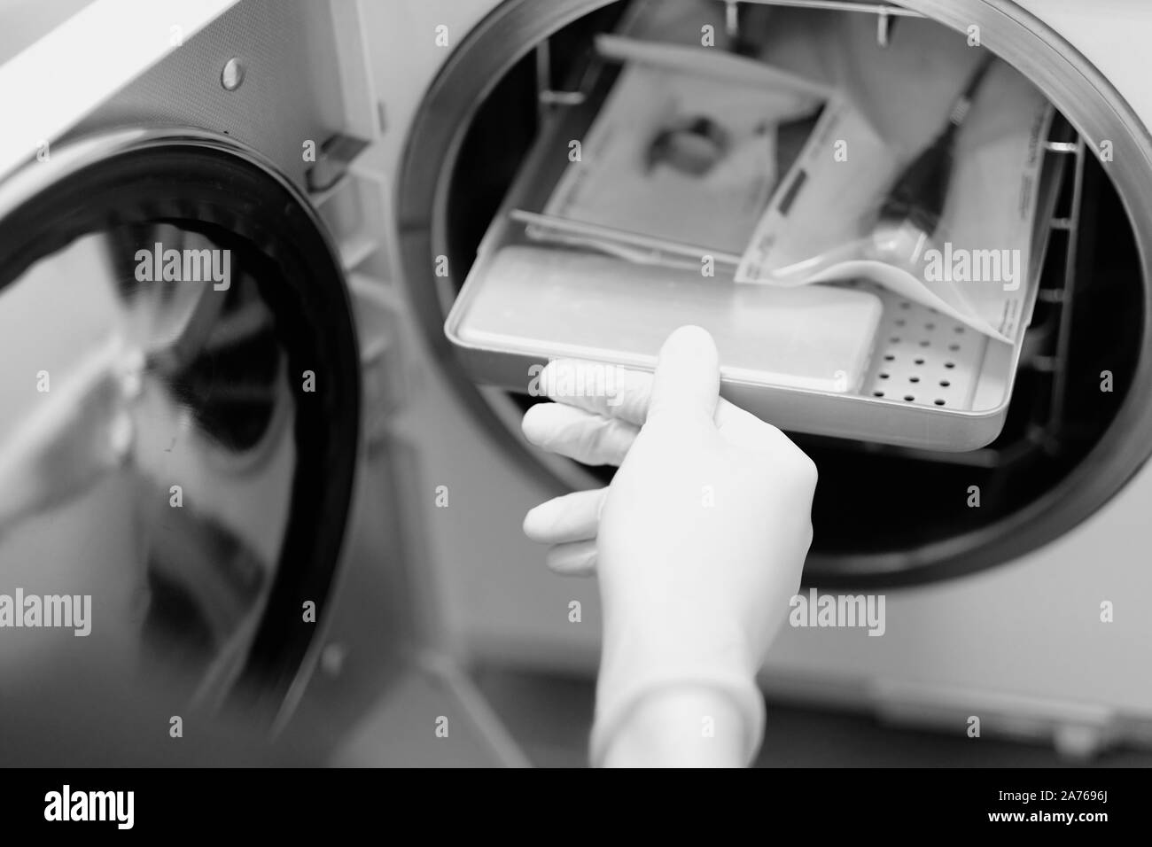 The dentist's assistant adds the packaged dental instrument to the ...