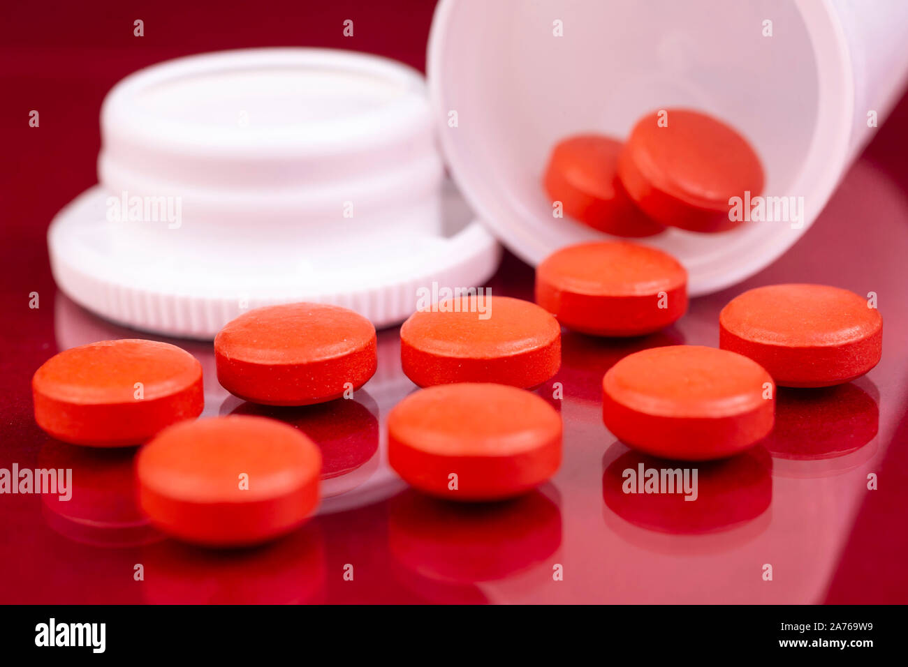 Red pills and white plastic bottle. Global pharmaceutical industry for ...