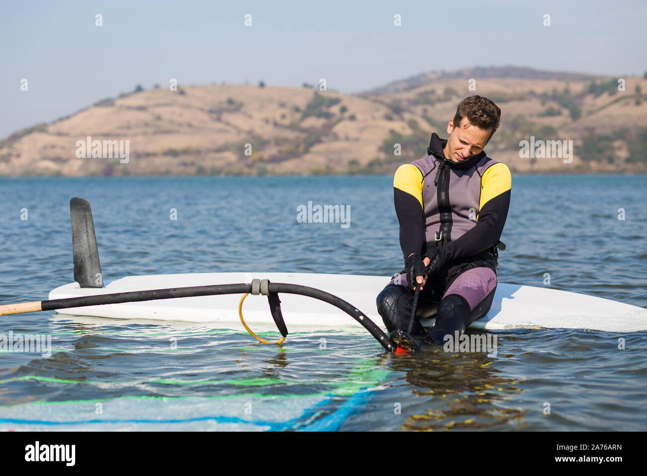 Muscular man holding surfing board hi-res stock photography and images ...