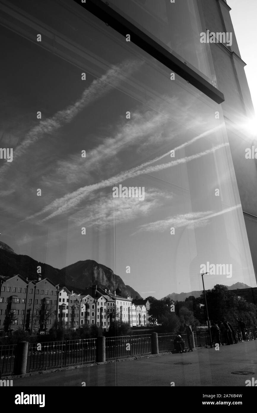 Black and white reflection off building with sun and mountains Stock ...