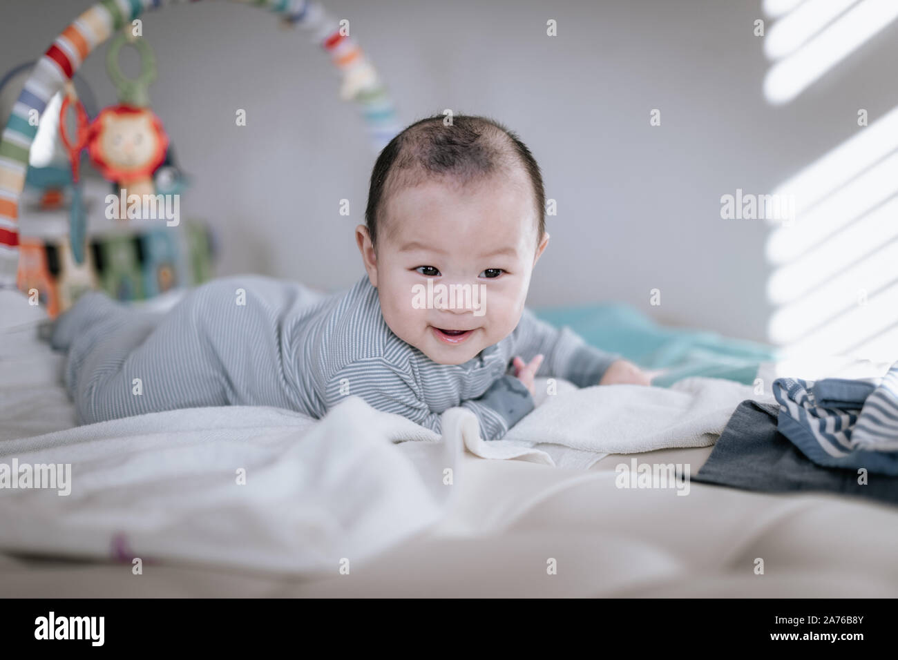 Asian baby boy doing tummy time at home Stock Photo - Alamy