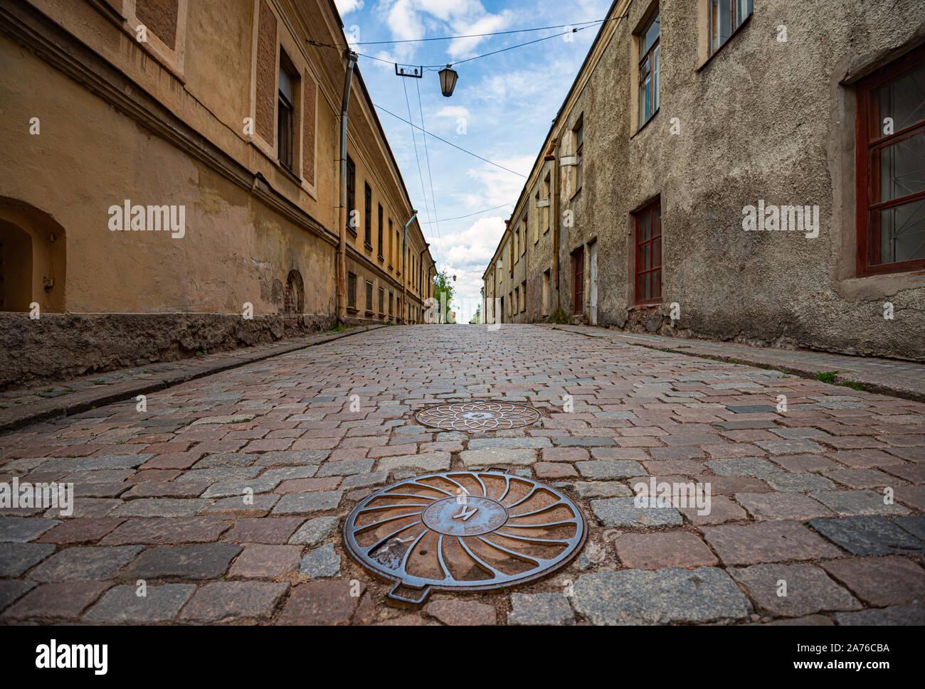 Old town street in Vyborg, Russia. Road with cobblestone floor. Blue ...