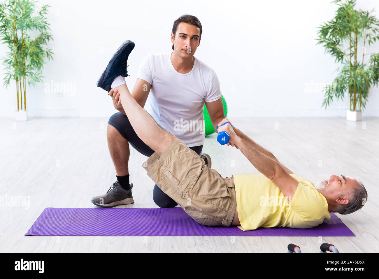 Senior man is doing rehab exercises at home hi-res stock photography ...
