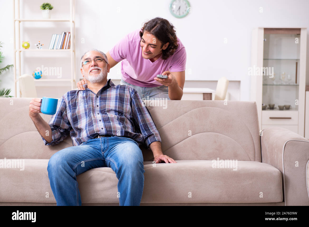 The young student and his old grandpa at home Stock Photo - Alamy