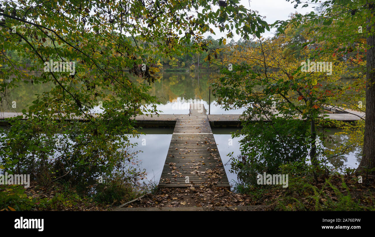 A scenic autumn view of a dock on a lake Stock Photo - Alamy