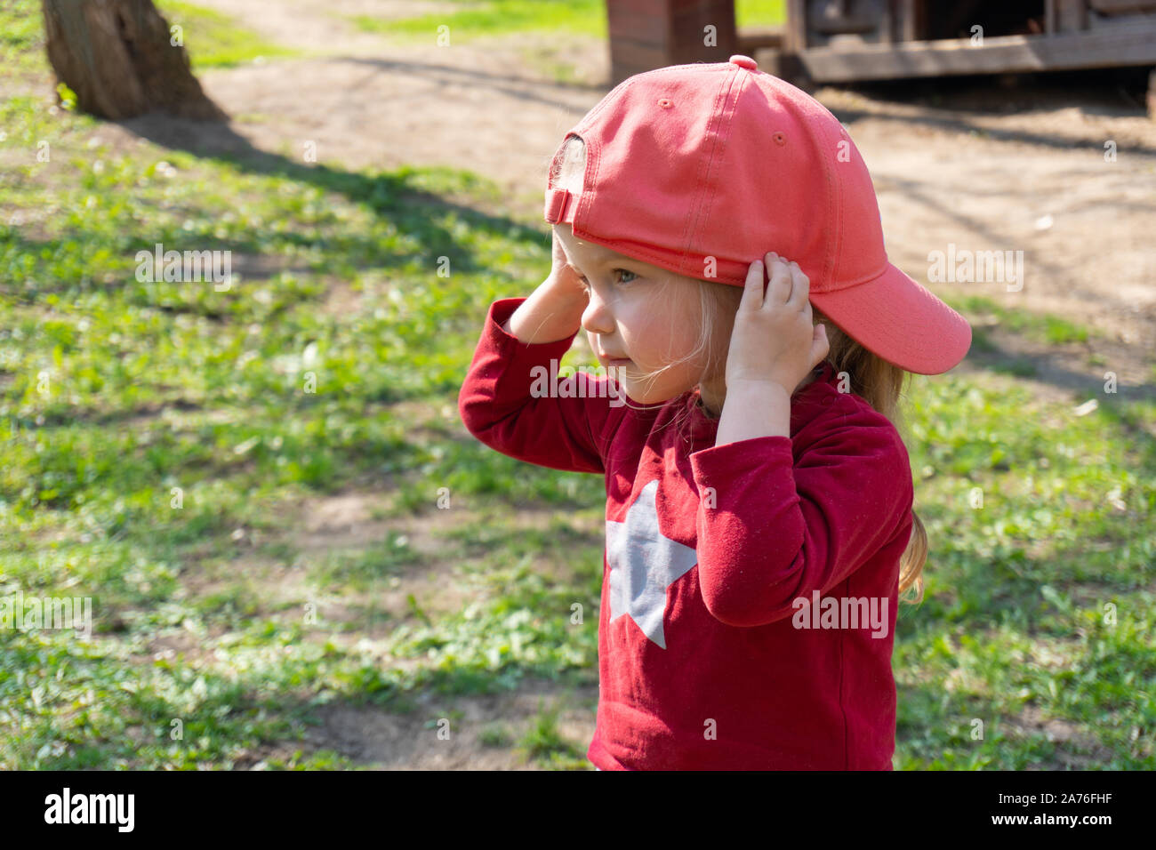 Adorable little kid girl in red cap Stock Photo - Alamy