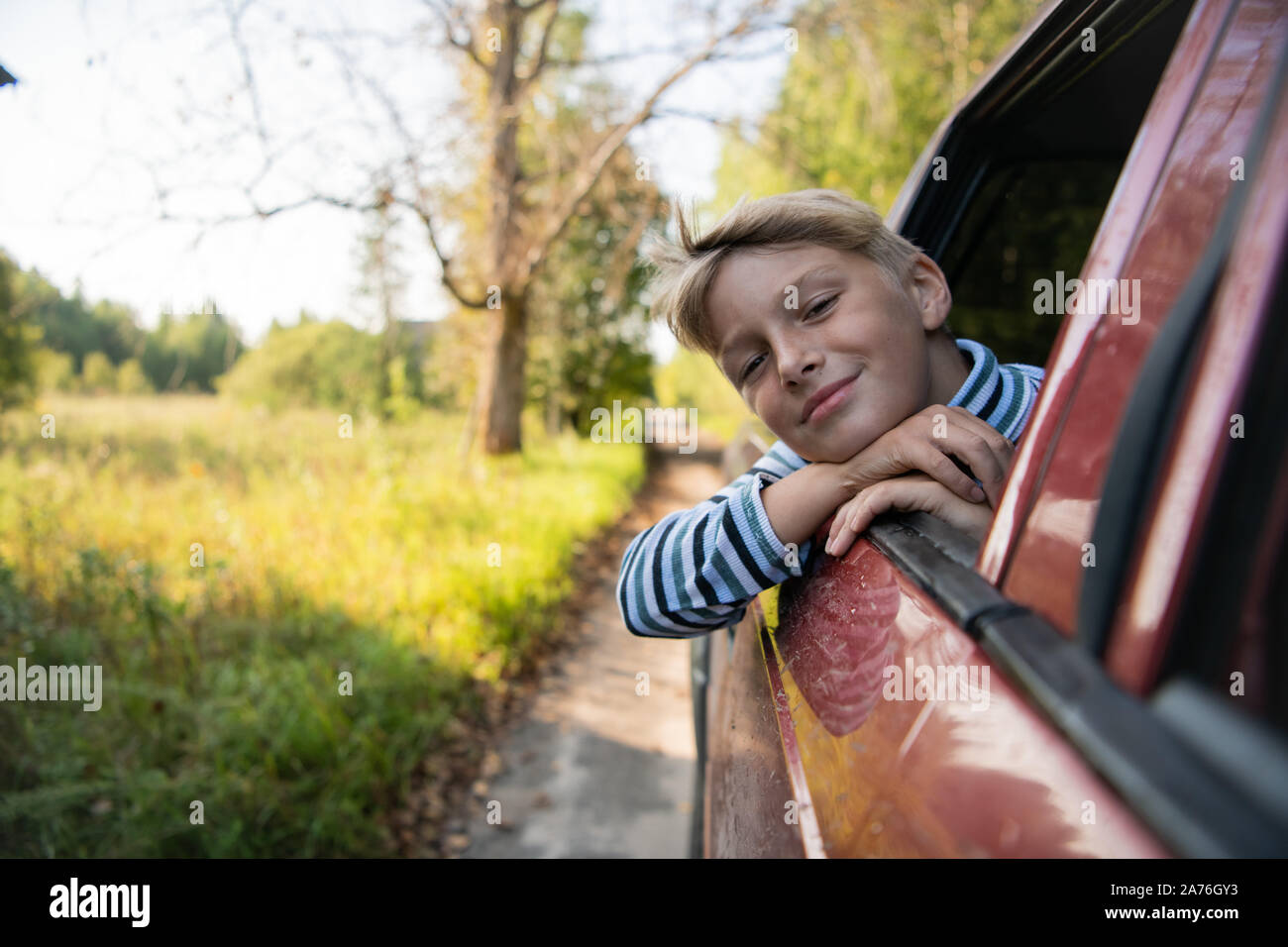Happy kid travel by the car. He popped out of the window Stock Photo ...