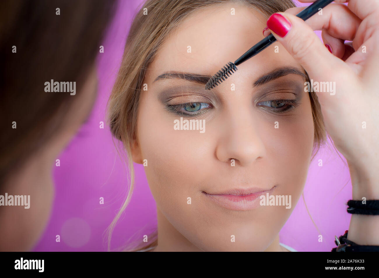 Makeup professional artist applying black mascara on lashes of model ...