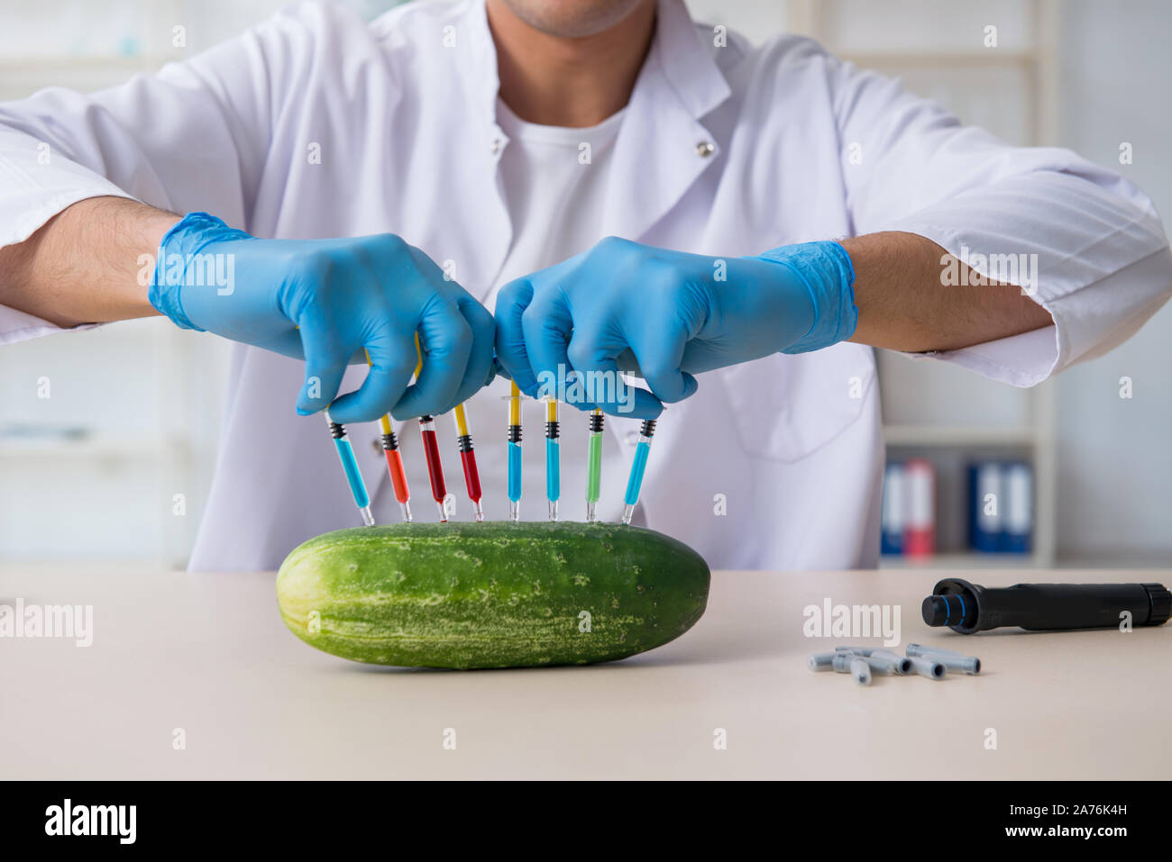 The male nutrition expert testing vegetables in lab Stock Photo - Alamy