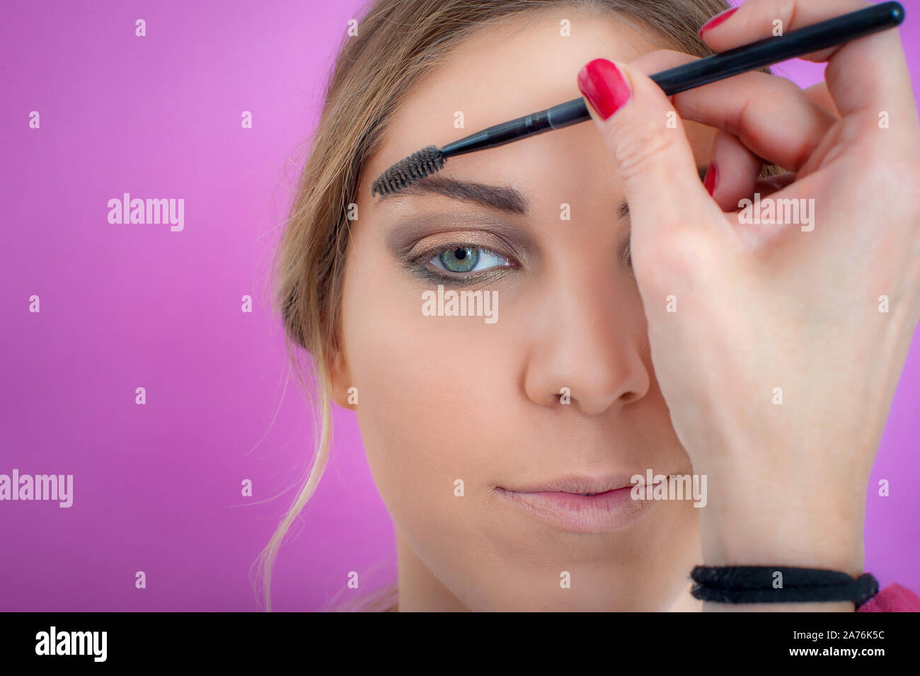 Makeup professional artist applying black mascara on lashes of model ...