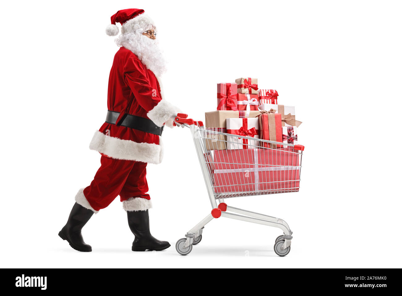 Full length profile shot of Santa Claus pushing a cart full of presents ...