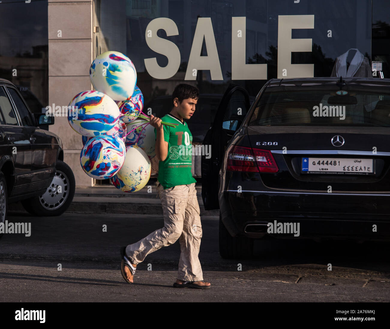 Boy selling balloons hi-res stock photography and images - Alamy