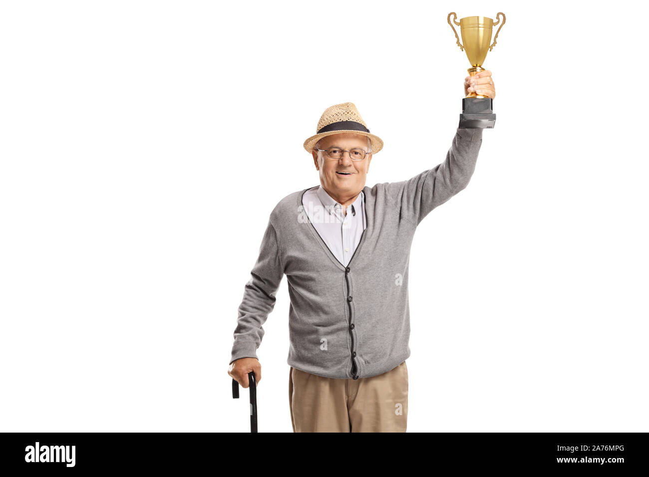 Elderly man standing with a cane and holding a gold trophy cup isolated ...