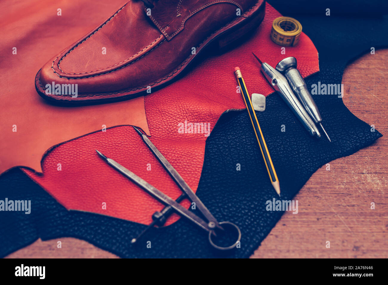 Shoemaker's work desk. Tools and leather at cobbler workplace. Man ...