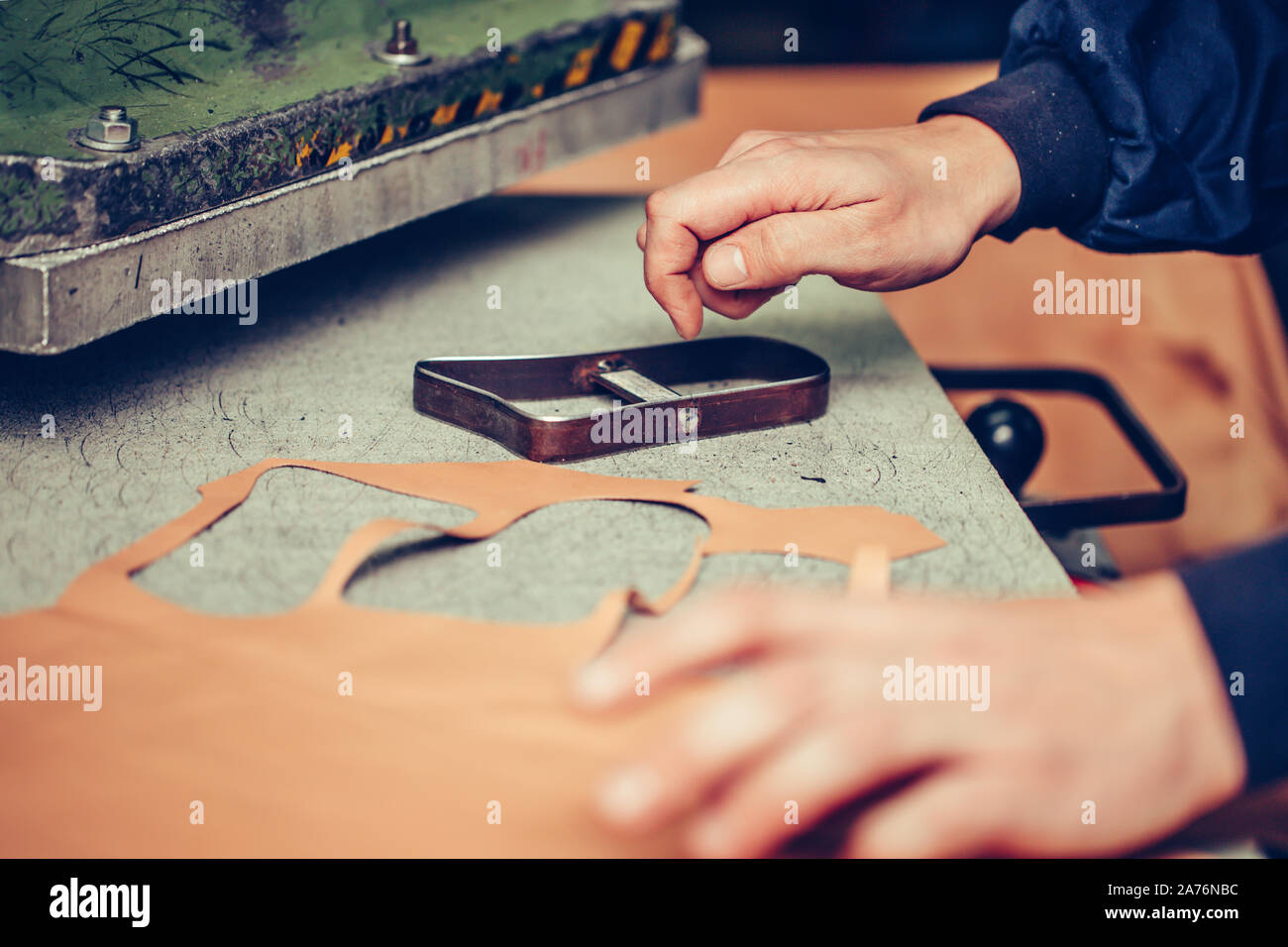 Close up of a shoemaker and cutting leather in the handmade footwear ...