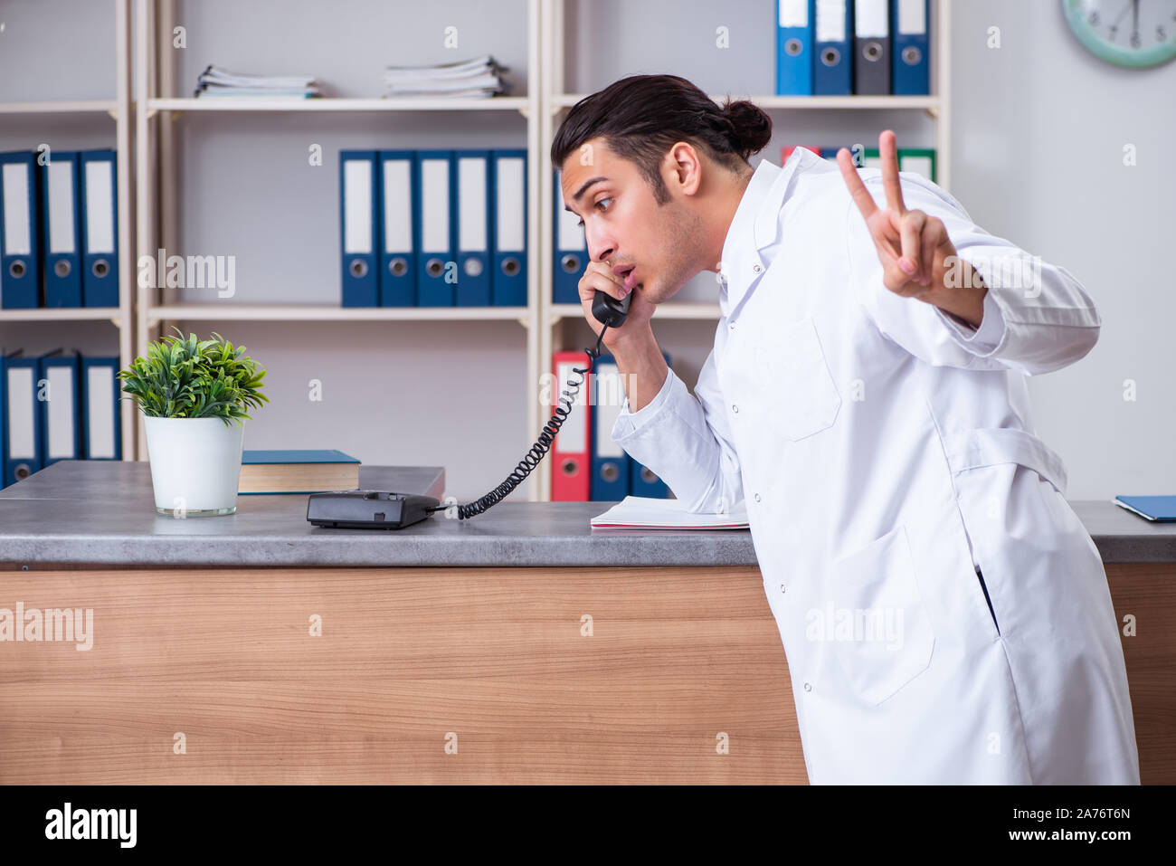 The young male doctor at the reception in the hospital Stock Photo - Alamy