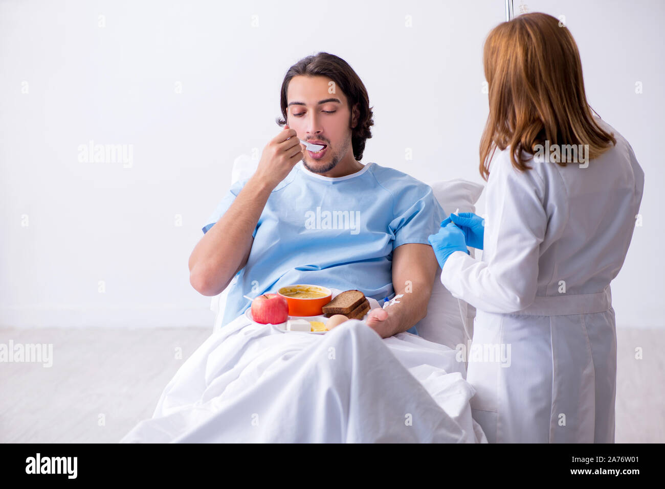 The male patient eating food in the hospital Stock Photo - Alamy
