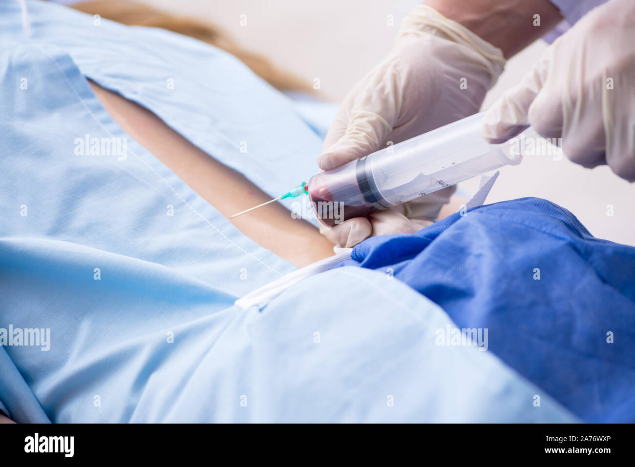 The female patient getting an injection in the clinic Stock Photo - Alamy