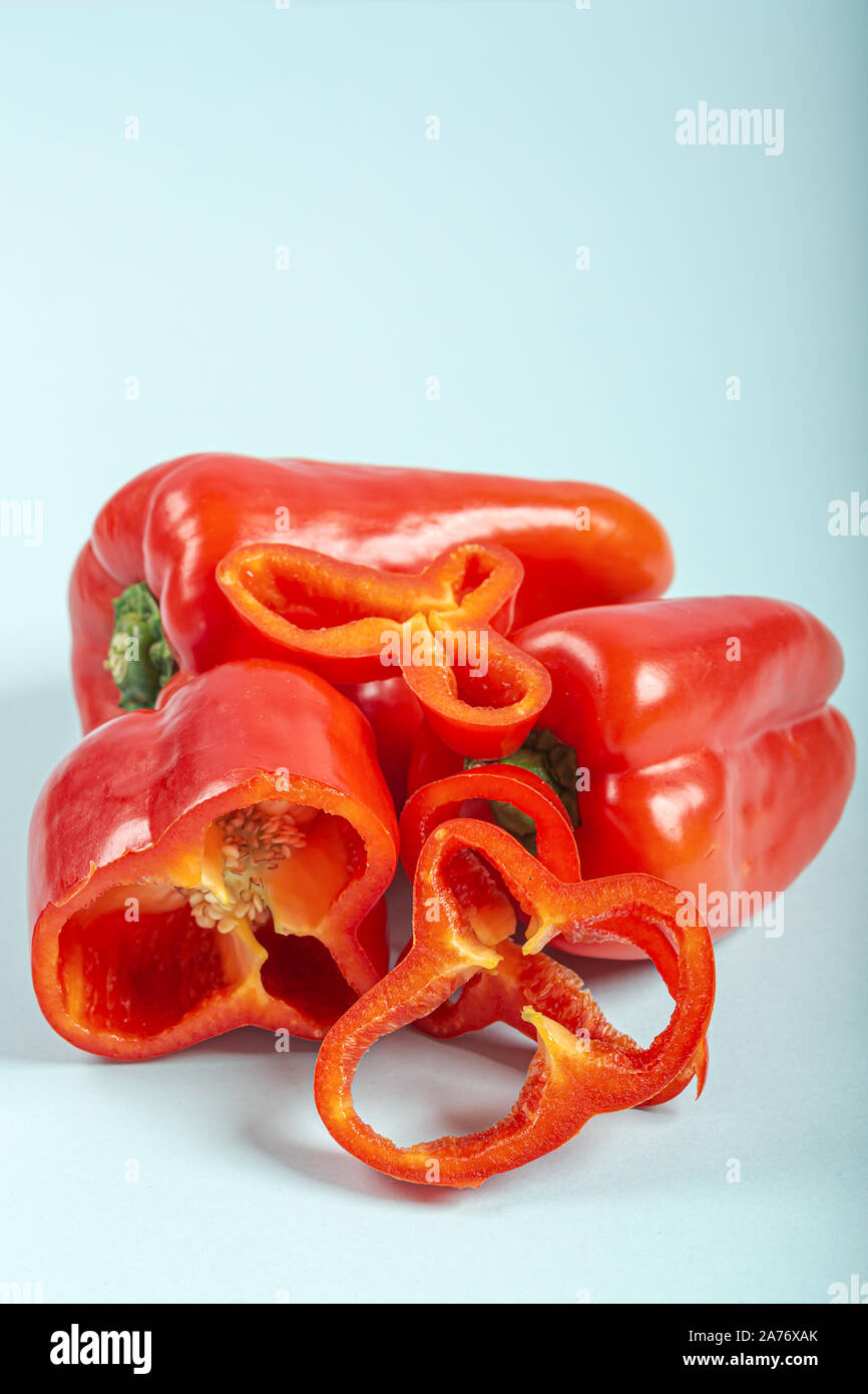 Sweet fresh red peppers on light blue background Stock Photo - Alamy