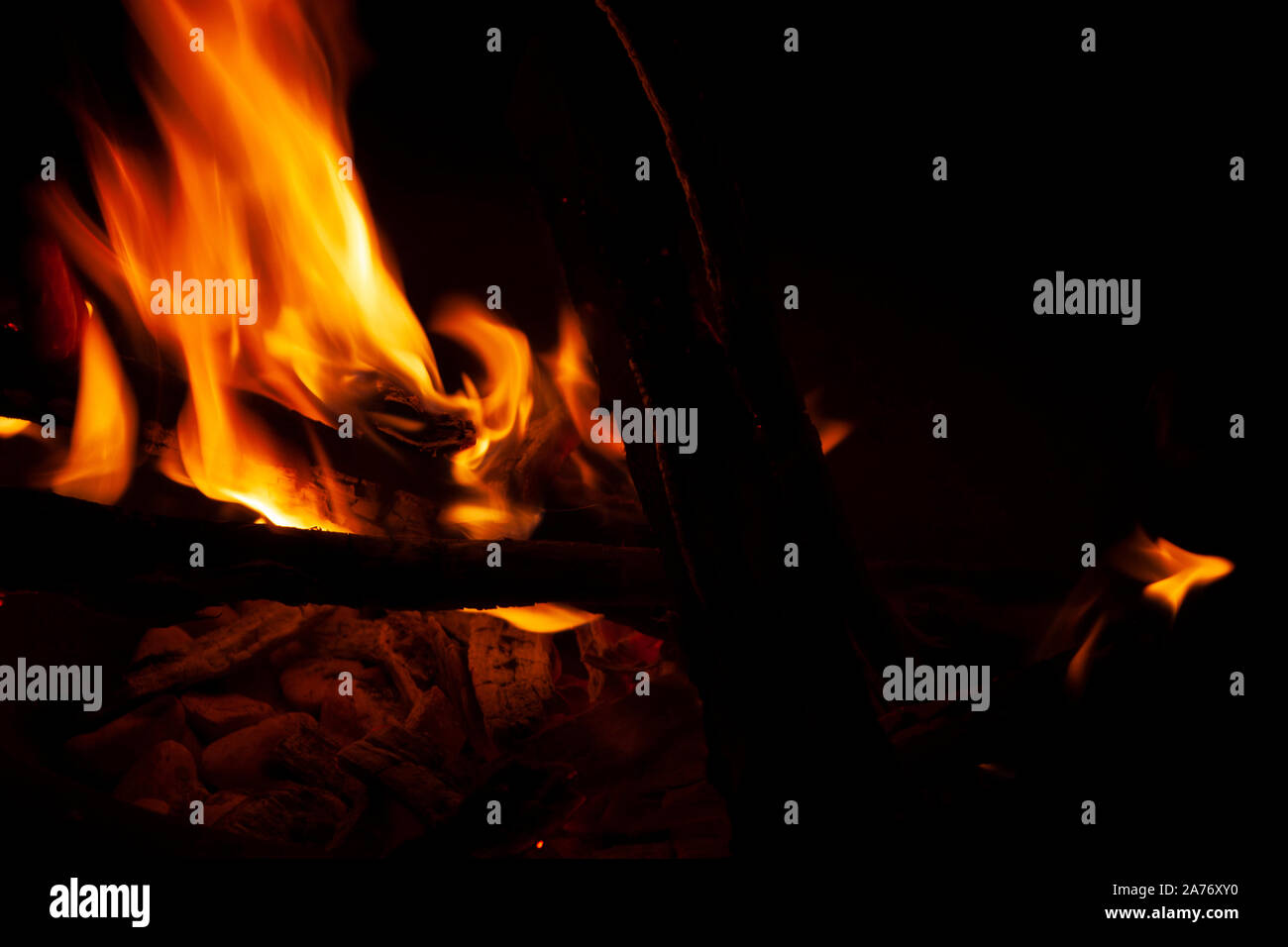 Trunks of dry trees fanning the flames of a stove photo taken with the ...