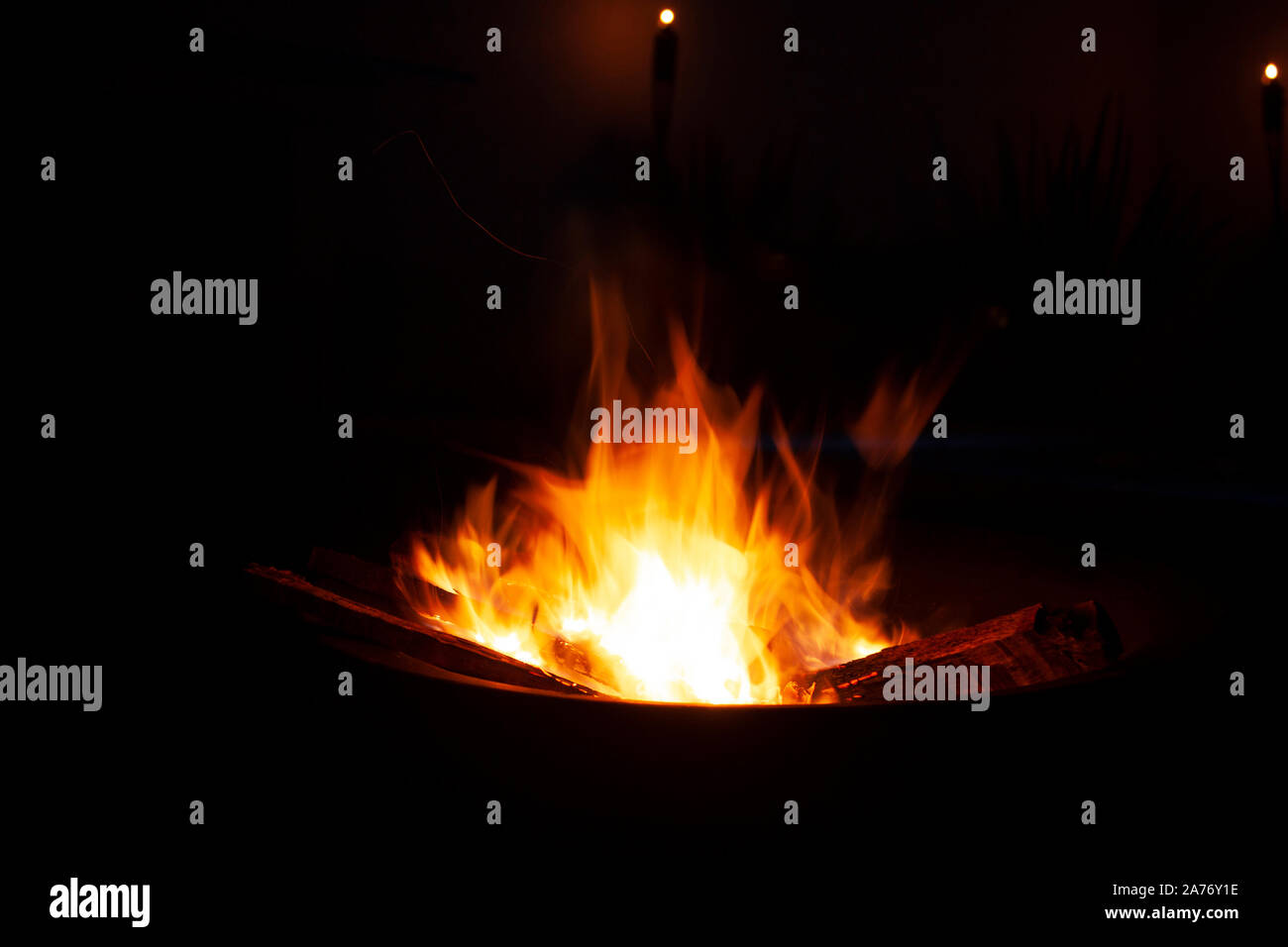 Fire lit by the hand of the man who placed dry tree trunks and branches ...