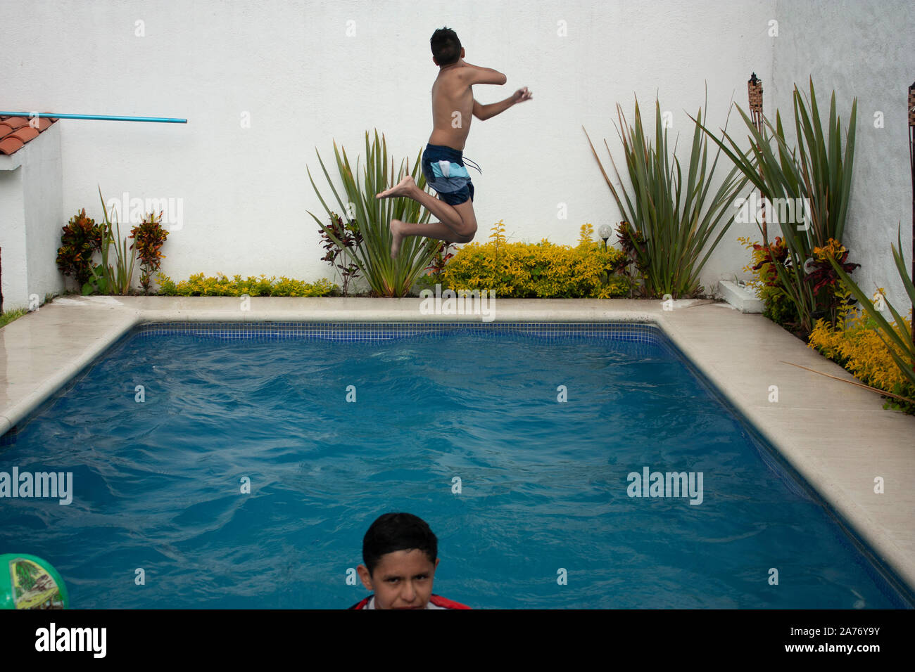Children playing in the pool diving and having fun Stock Photo - Alamy