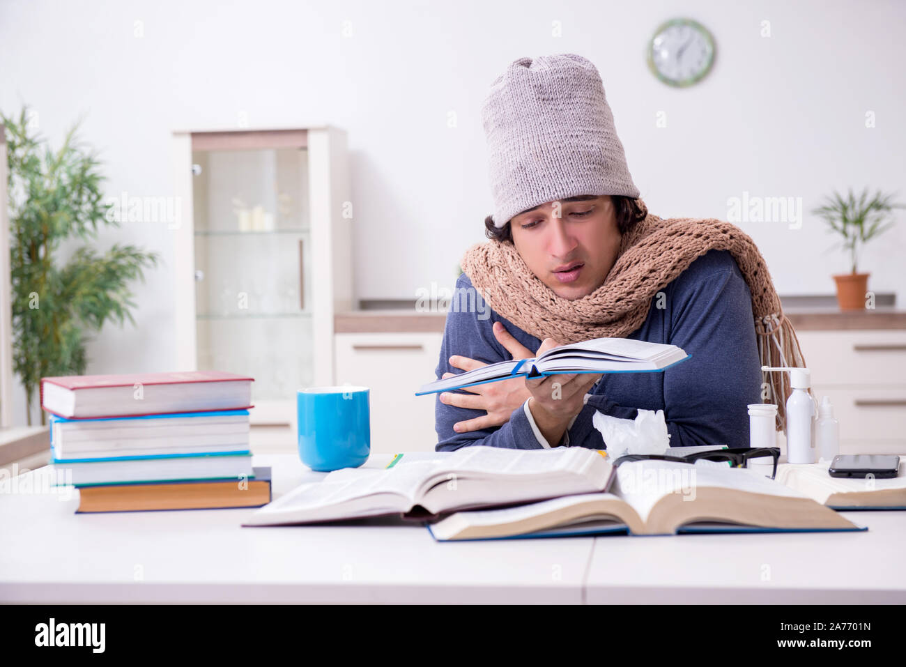 The sick male student suffering at home Stock Photo - Alamy