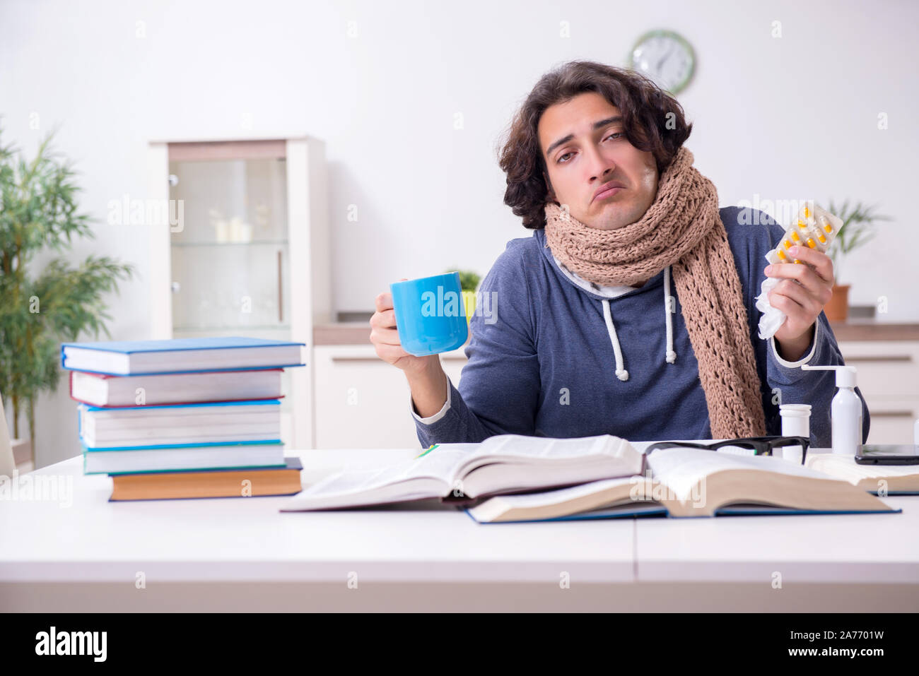 The sick male student suffering at home Stock Photo - Alamy