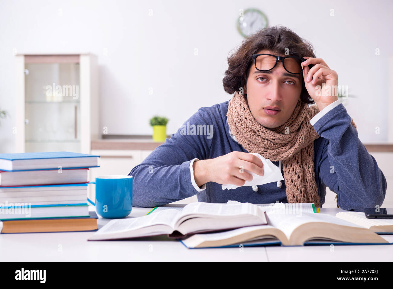 The sick male student suffering at home Stock Photo - Alamy
