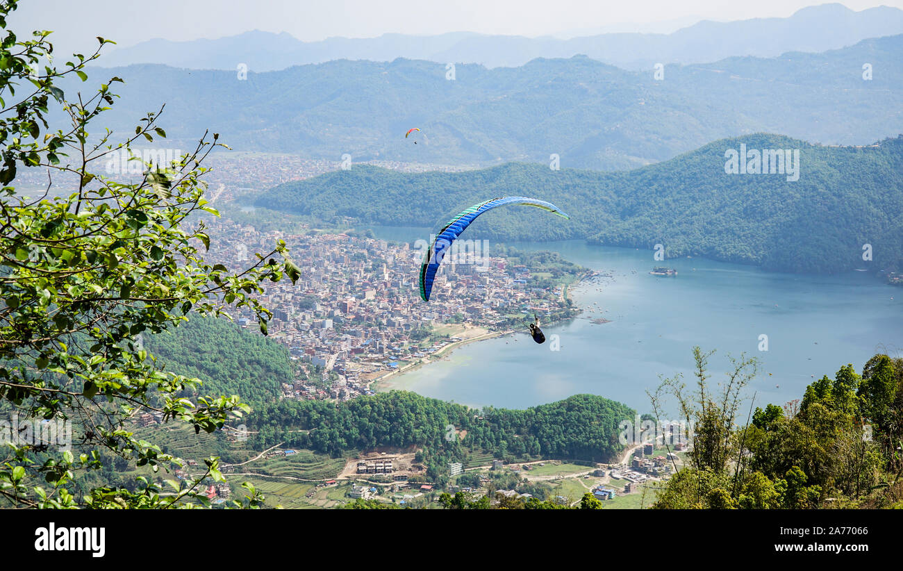 Paragliders flying against the Himalayas , Pokhara , Nepal Stock Photo ...