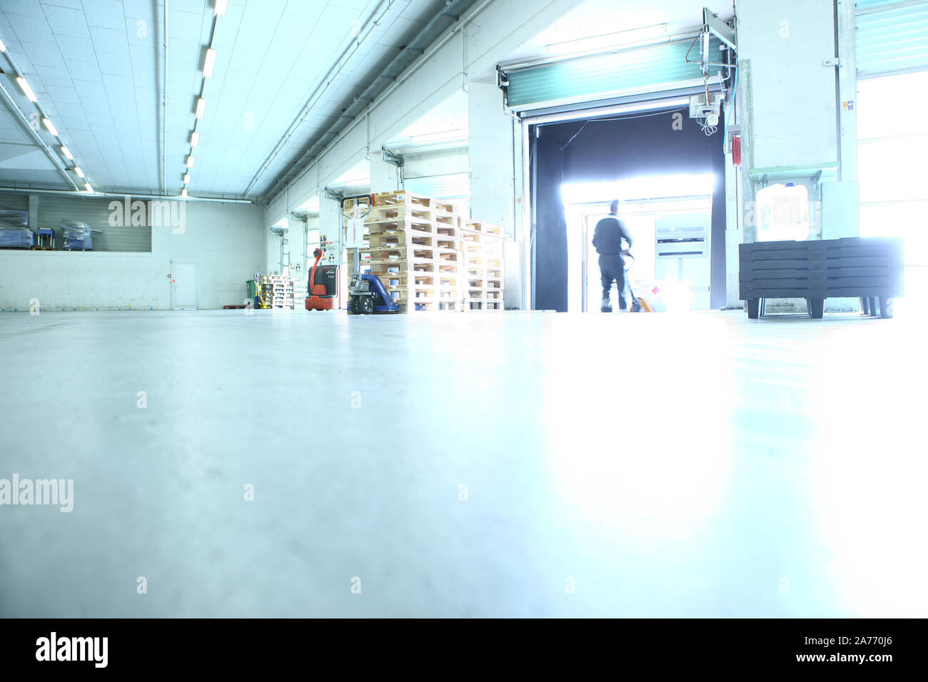 Workers in a warehouse loading up a car Stock Photo - Alamy