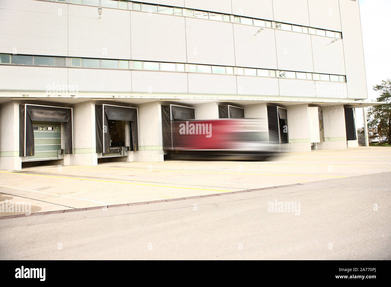 Workers in a warehouse loading up a car Stock Photo - Alamy