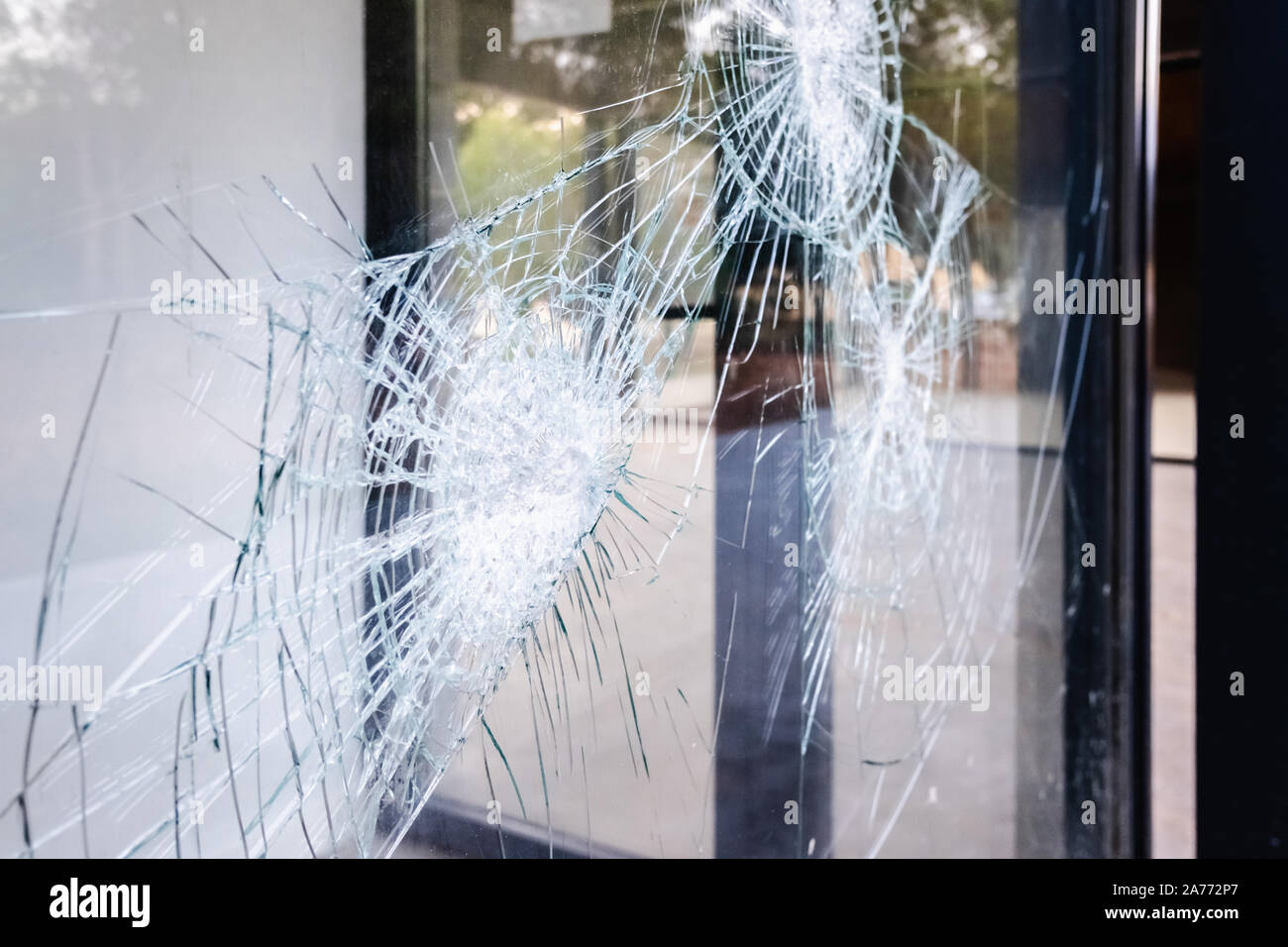 Glass of a broken and cracked commercial showcase Stock Photo - Alamy