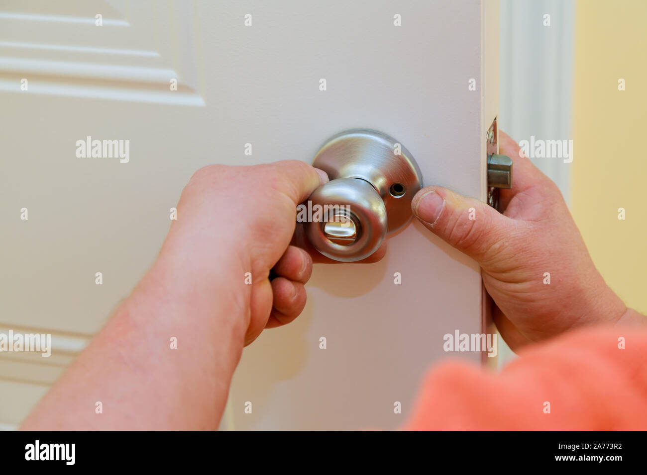 Male carpenter fixing lock in door with home hand close-up Stock Photo ...