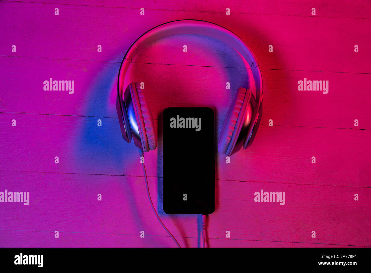 Top view of set of gadgets in purple neon light and pink background ...