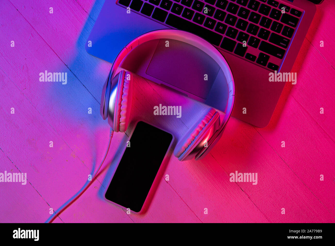 Top view of set of gadgets in purple neon light and pink background ...