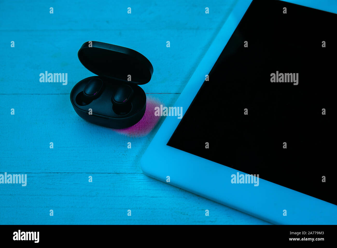 Top view of set of gadgets in purple neon light and blue background ...