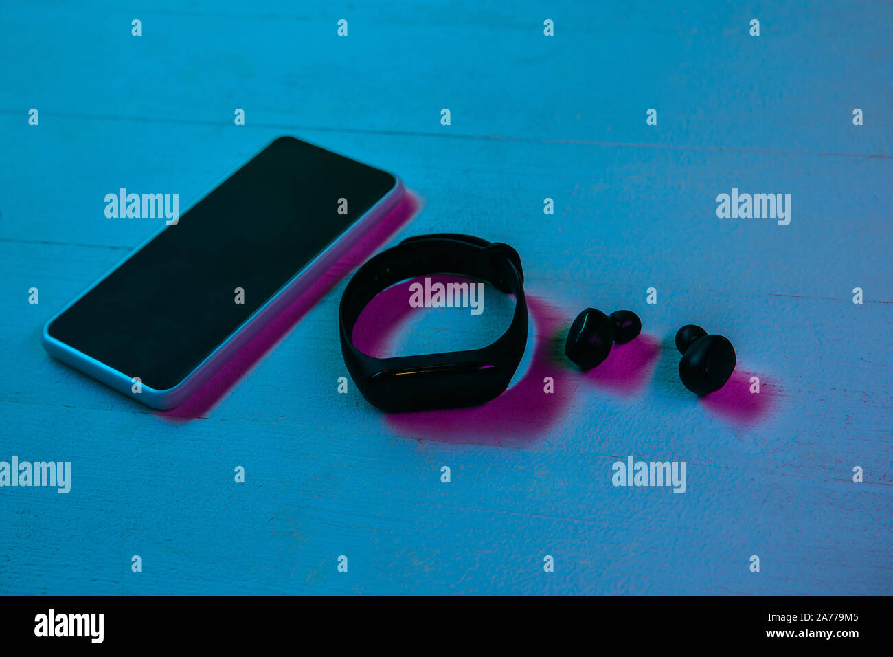Top view of set of gadgets in purple neon light and blue background ...
