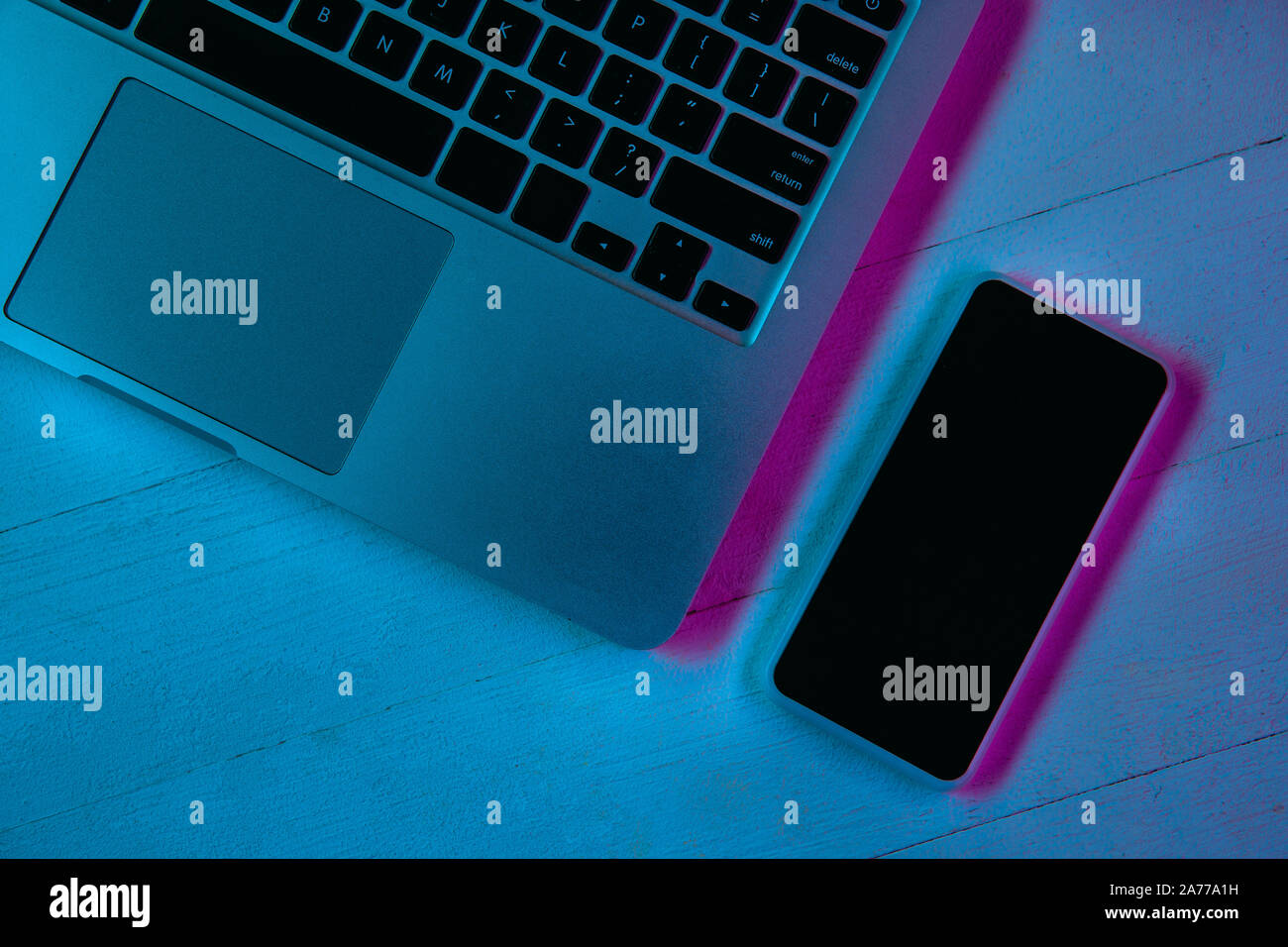 Top view of set of gadgets in purple neon light and blue background ...