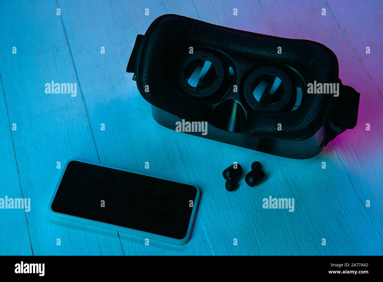 Top view of set of gadgets in purple neon light and blue background ...