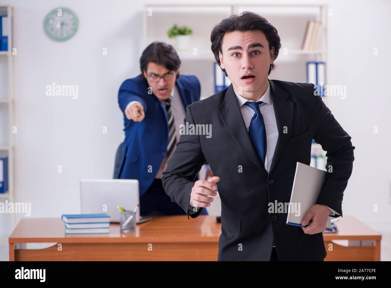 The boss and his male assistant working in the office Stock Photo - Alamy