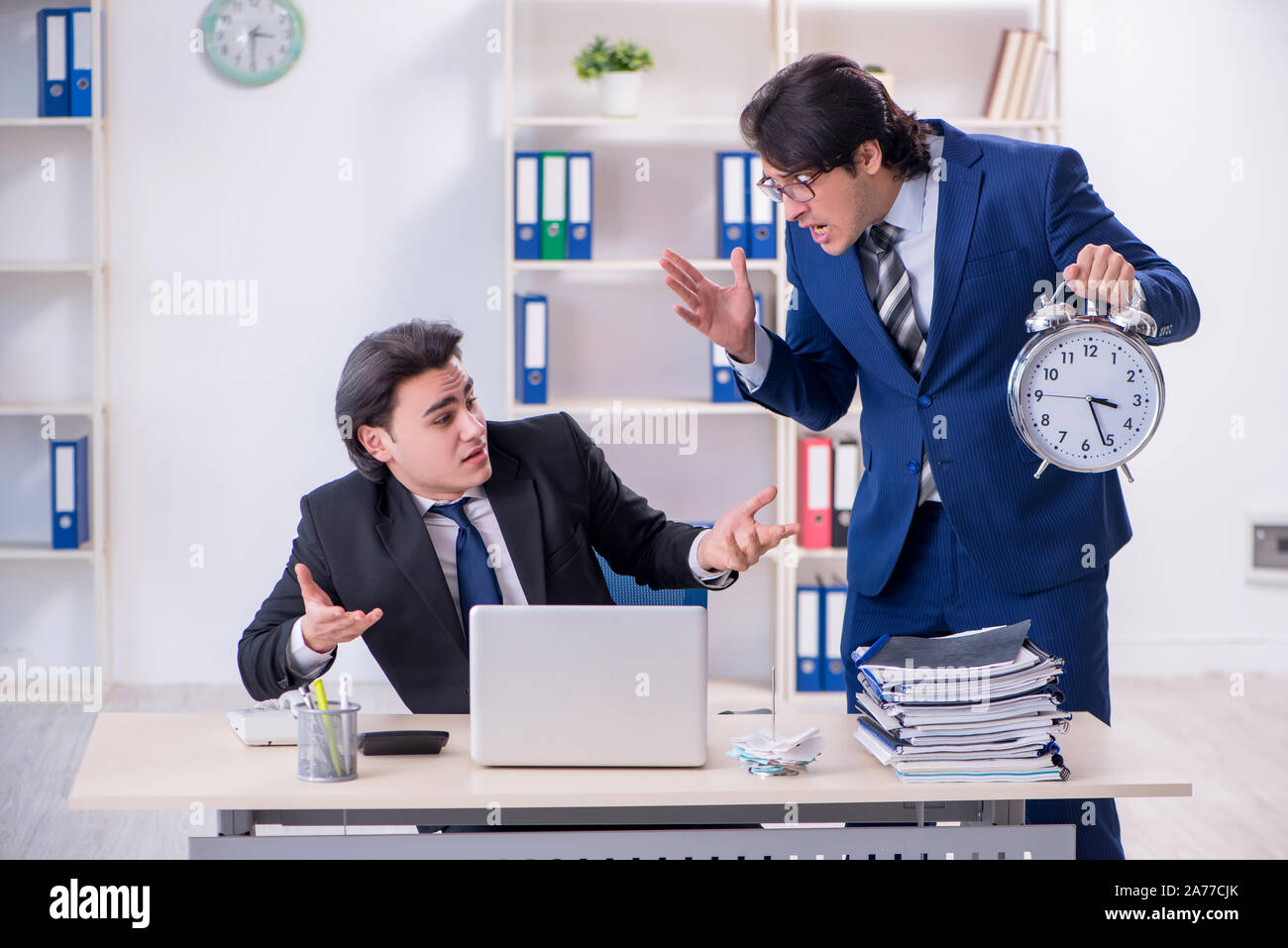 The boss and his male assistant working in the office Stock Photo - Alamy